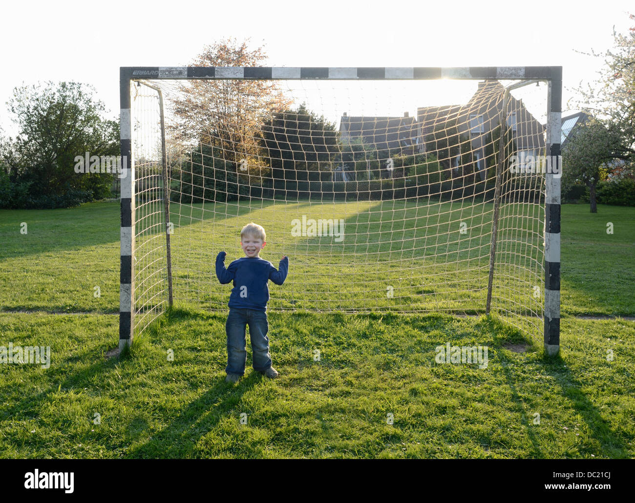 Boy cheering in goal Stock Photo - Alamy