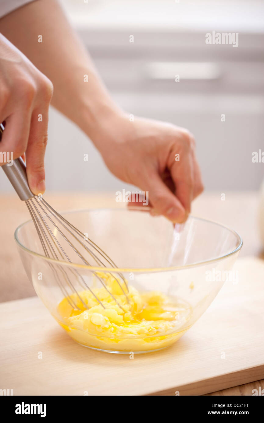 mixing butter and eggs in a bowl Stock Photo - Alamy