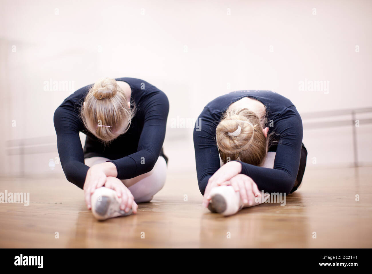 Two ballerinas in pose on studio floor Stock Photo - Alamy