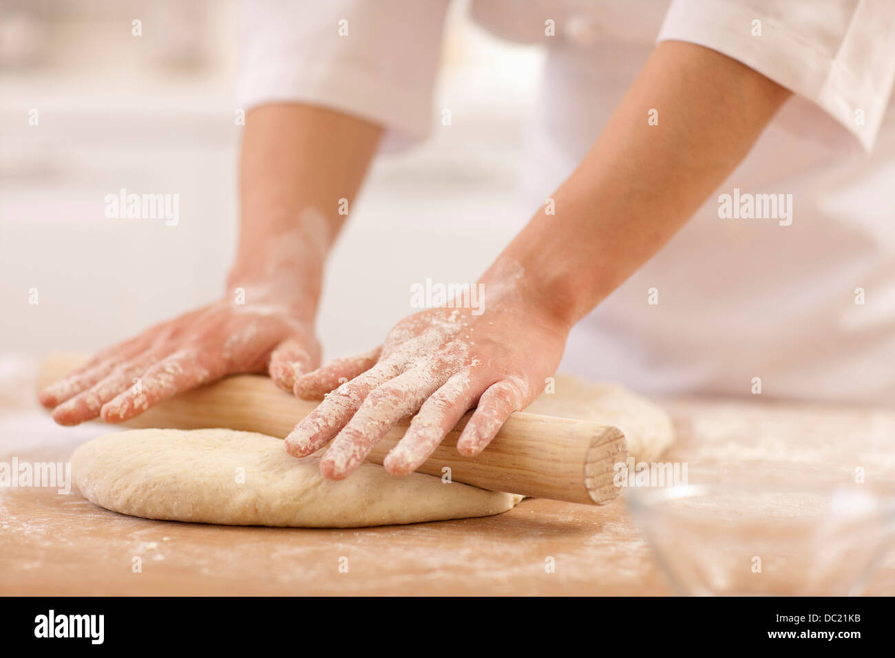 making bread dough flat with a roller Stock Photo - Alamy