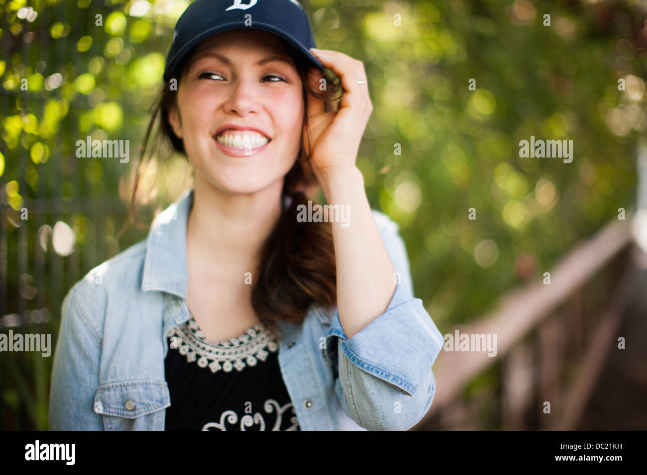 Mid adult woman wearing cap and smiling Stock Photo - Alamy