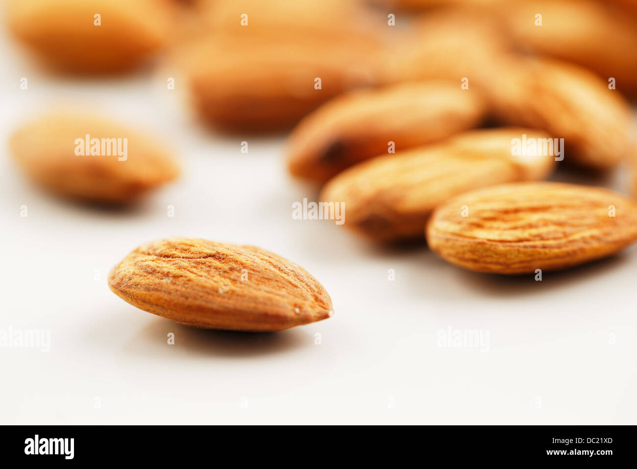 A handful of almonds on a white background Stock Photo - Alamy