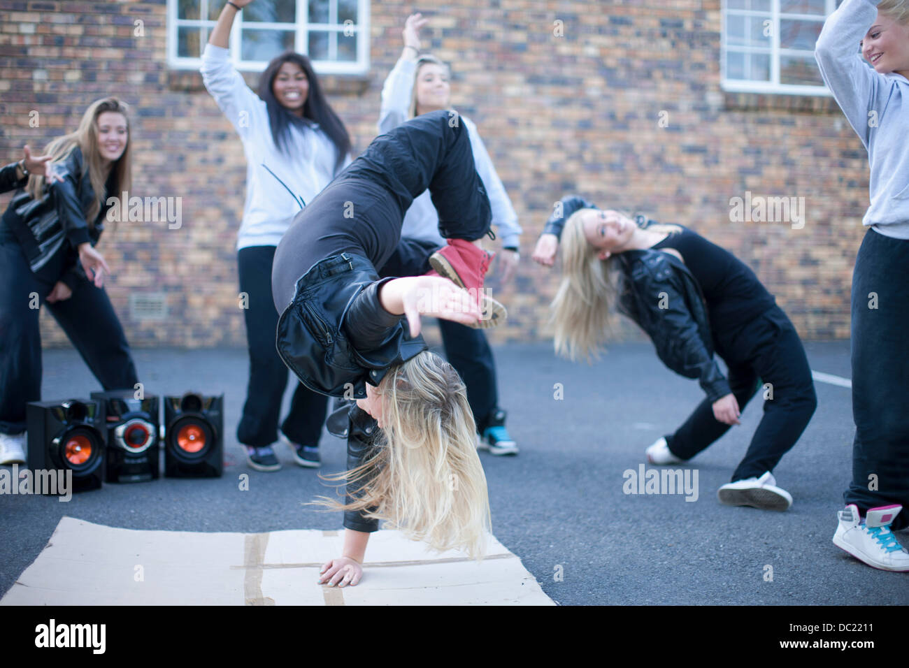 Blond girl breakdancing in playground Stock Photo - Alamy