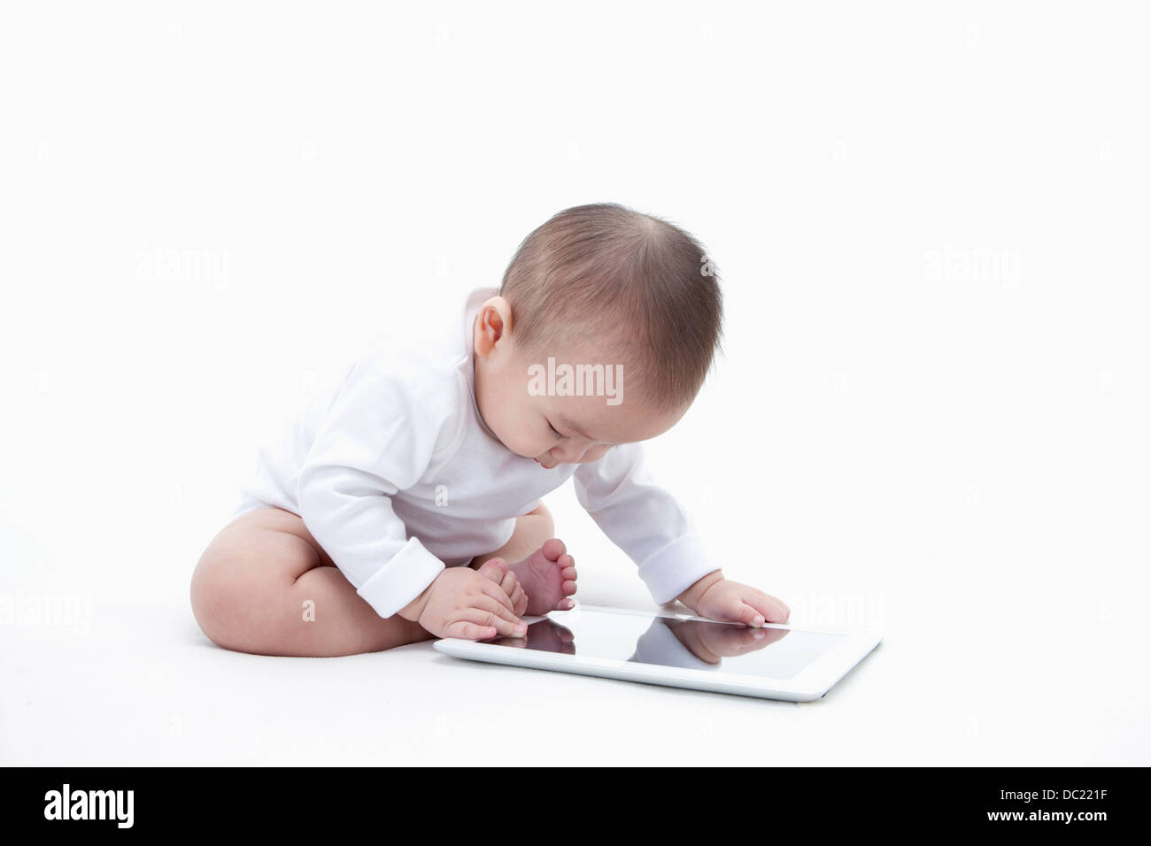 a baby playing with a tablet PC Stock Photo - Alamy