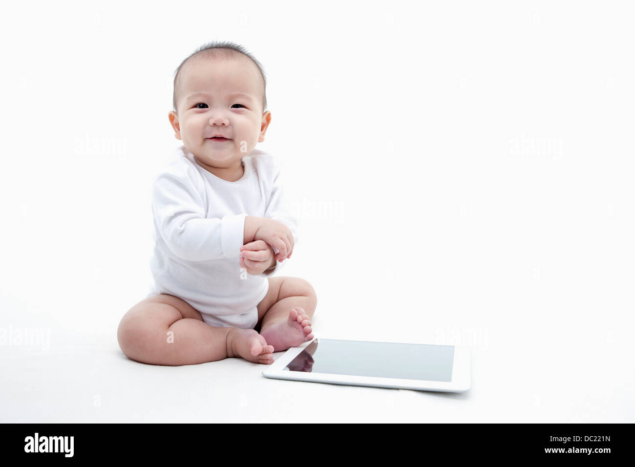 a baby playing with a tablet PC Stock Photo - Alamy