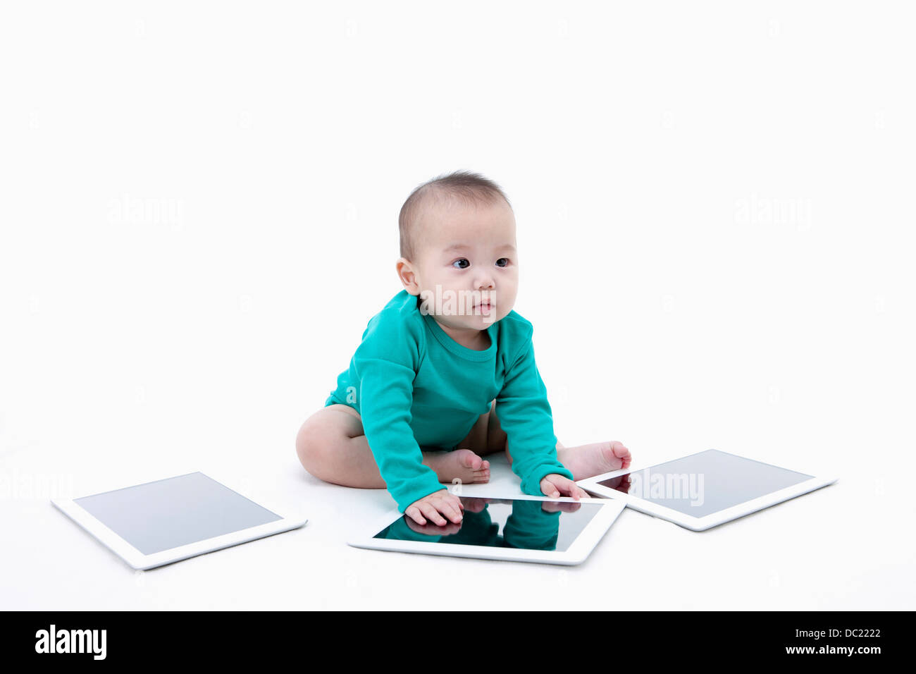 a baby playing with many tablet PCs Stock Photo - Alamy