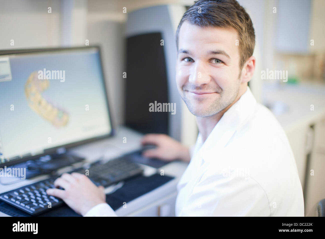 Dental technician using computer to design denture Stock Photo - Alamy