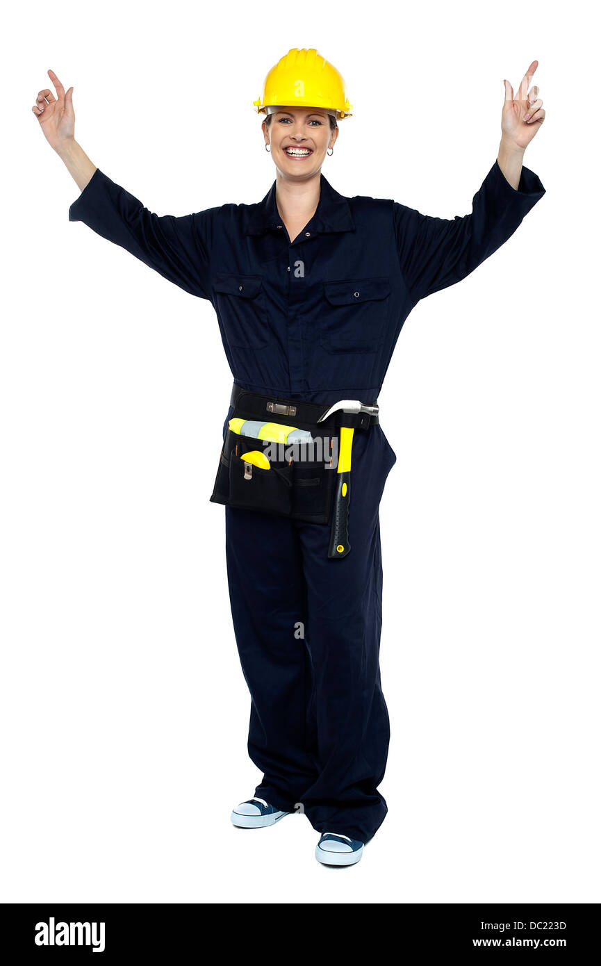 Smiling lady worker in jumpsuit raising her hands Stock Photo - Alamy