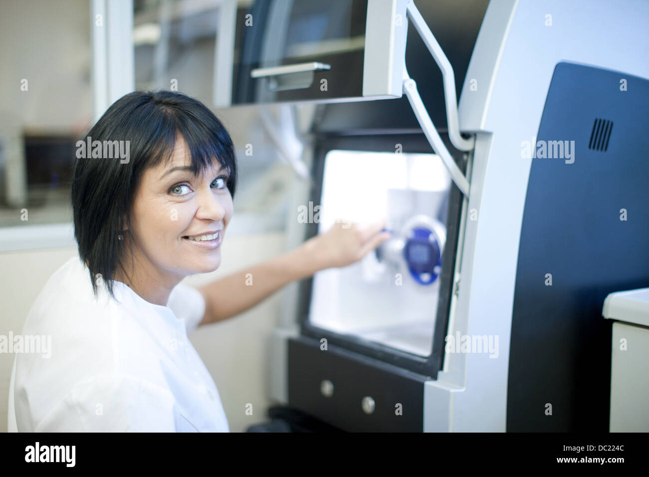 Dental technician using equipment to produce denture Stock Photo - Alamy