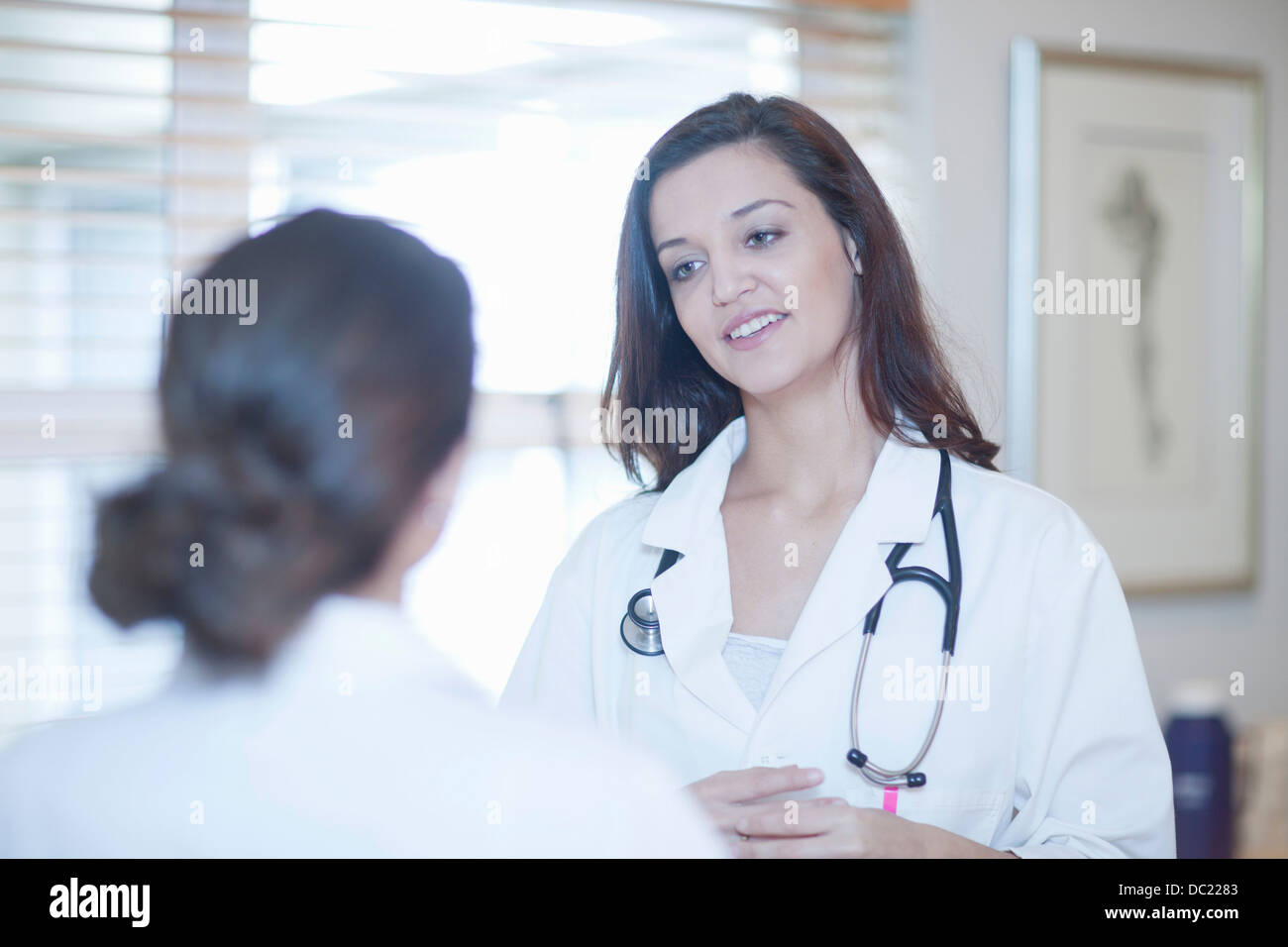 Doctor and nurse chatting Stock Photo - Alamy