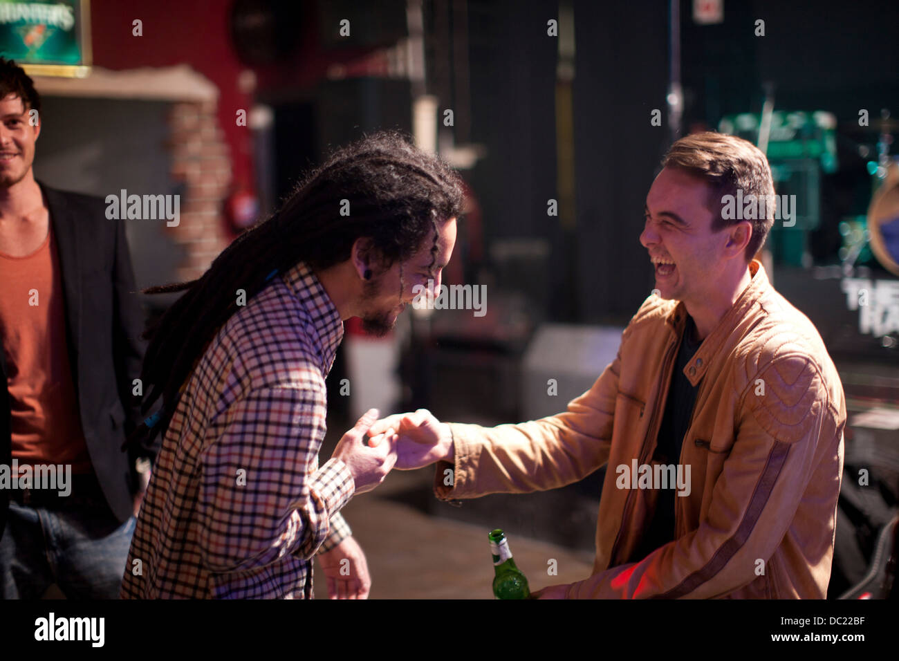 Two men greeting in bar Stock Photo - Alamy