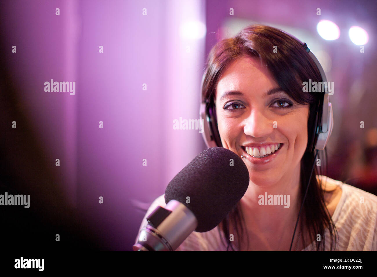 Mid adult woman broadcasting in recording studio, portrait Stock Photo ...