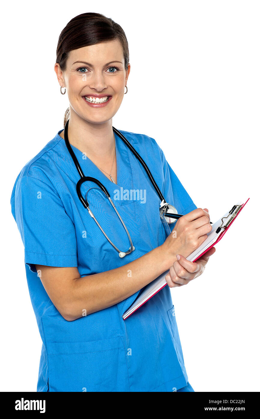 Smiling medical practitioner filling out the records Stock Photo - Alamy
