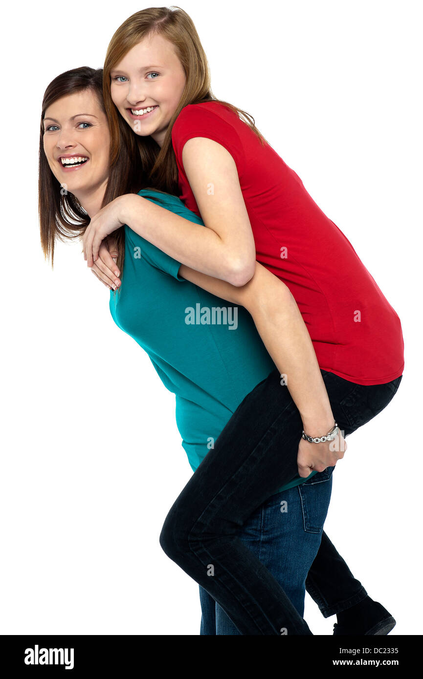 Happy mother giving piggyback ride to her daughter Stock Photo - Alamy