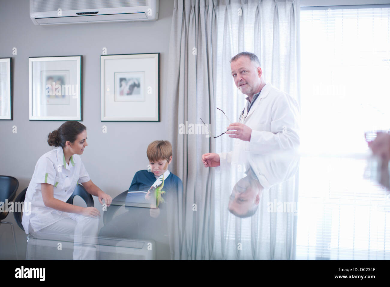 Nurse, doctor and young patient in hospital reception Stock Photo - Alamy