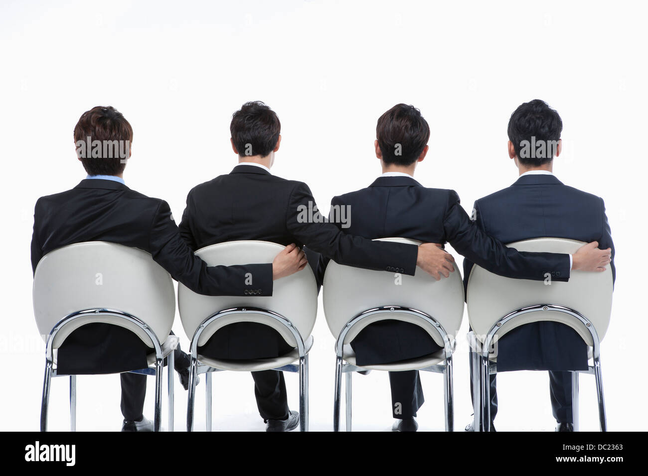 back shot of businessmen sitting on chairs in a line Stock Photo - Alamy
