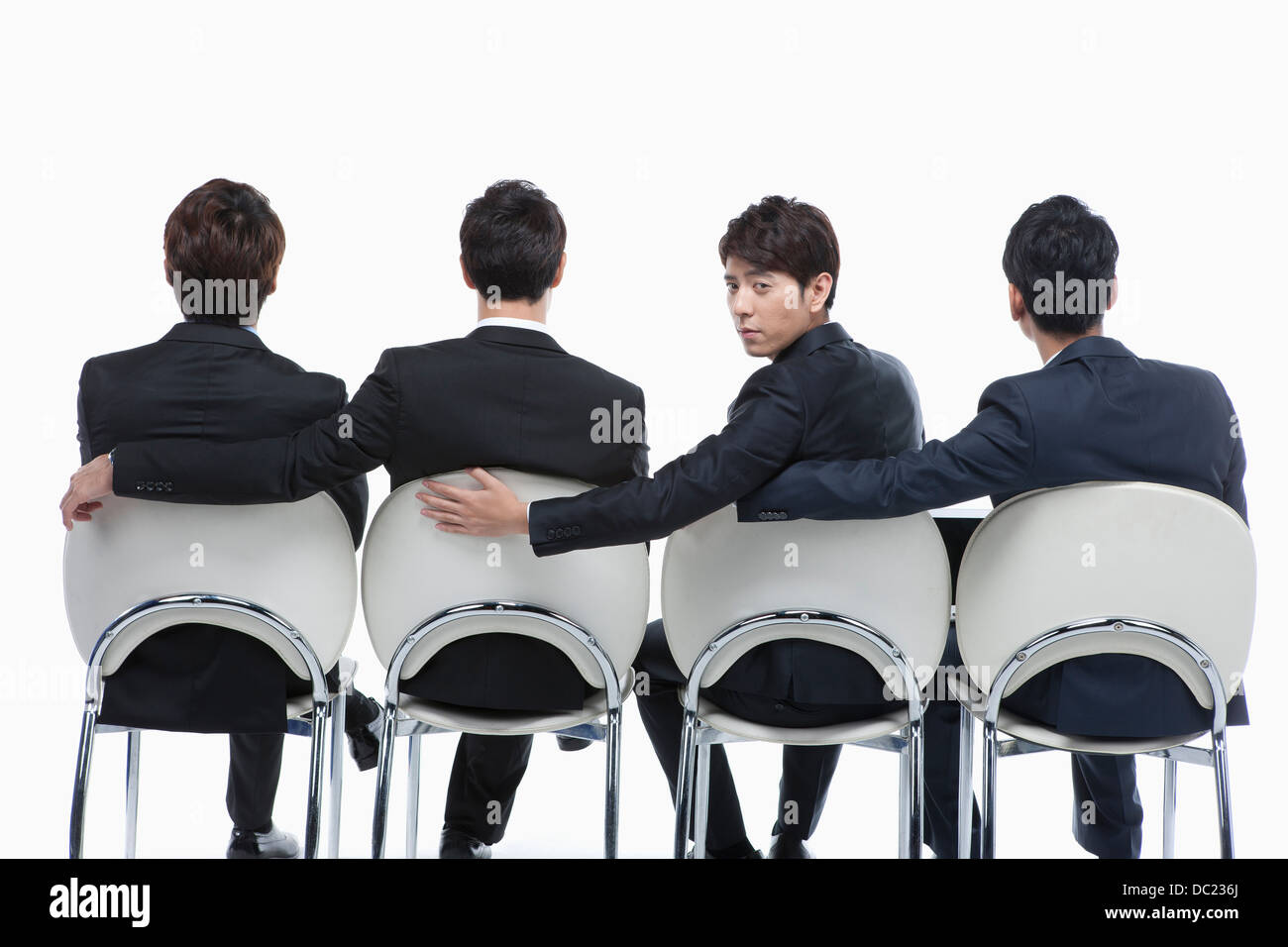 back shot of businessmen sitting on chairs in a line Stock Photo - Alamy