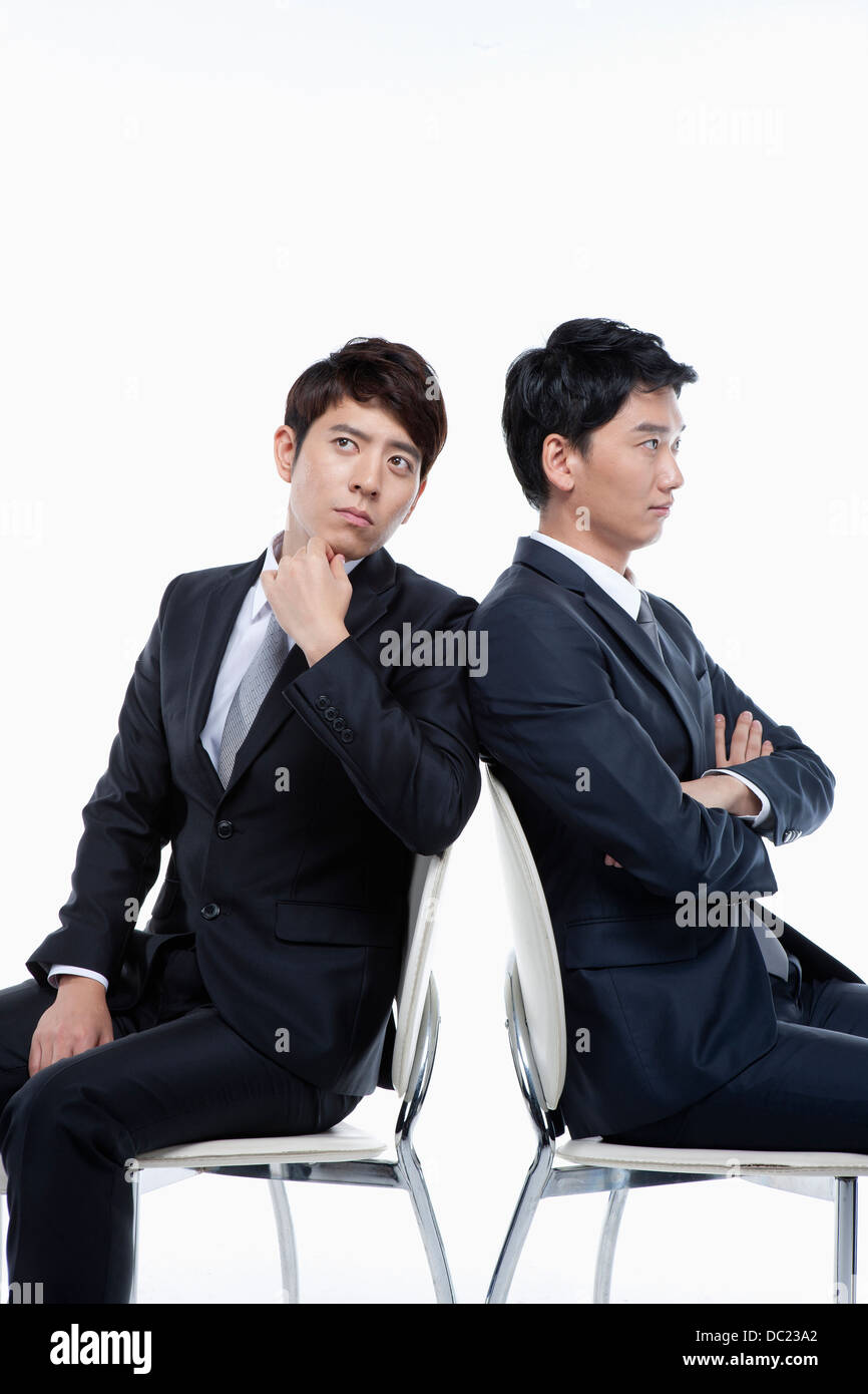 businessmen sitting back to back Stock Photo - Alamy