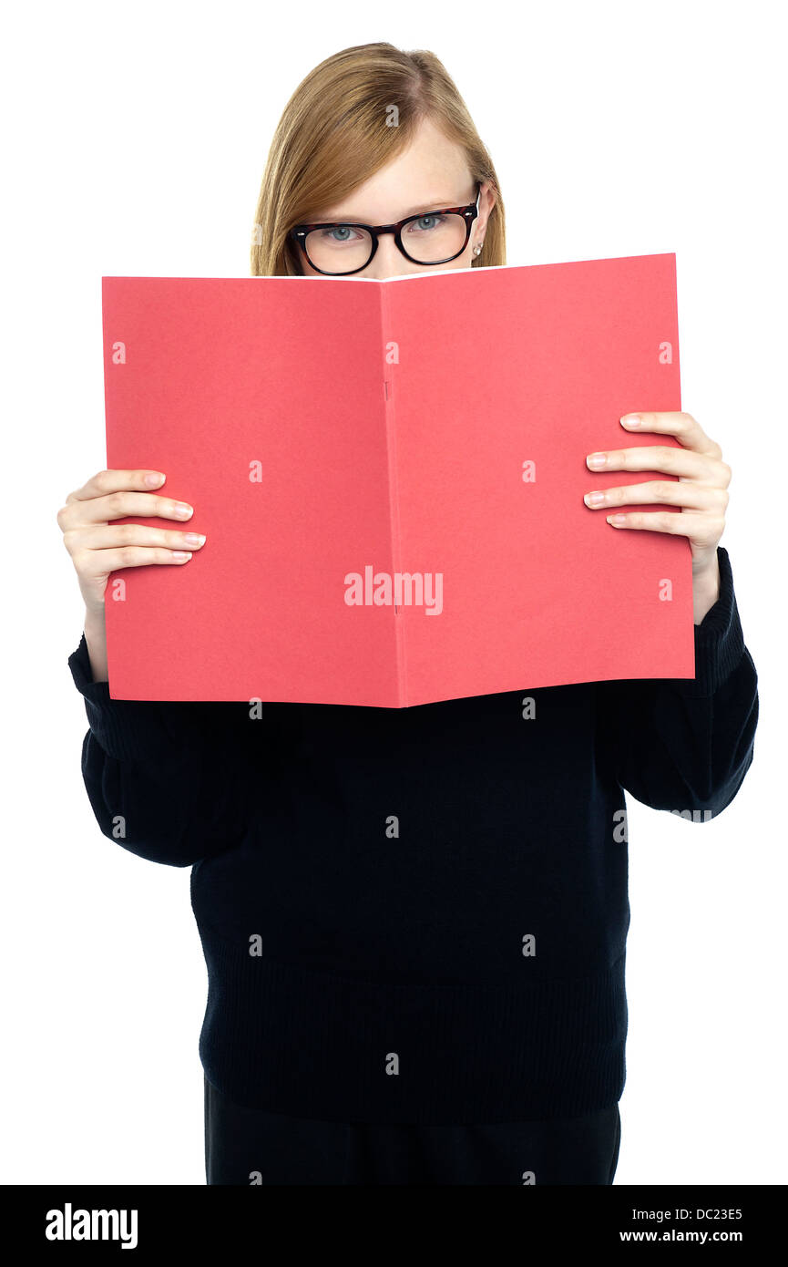 Student with a red book learning intently Stock Photo - Alamy