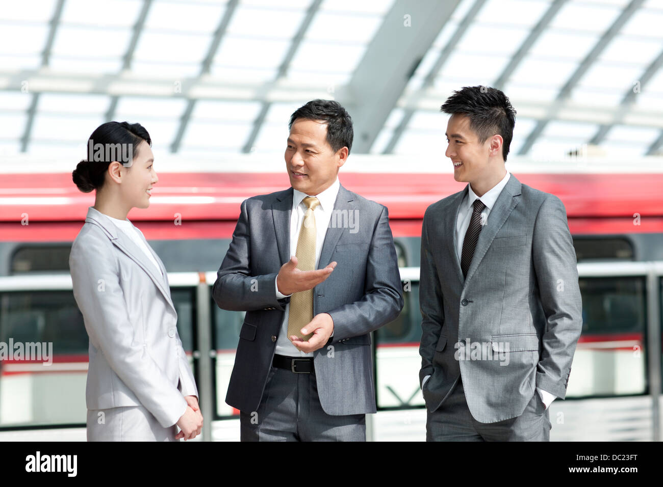 Chinese business persons talking at subway station Stock Photo - Alamy