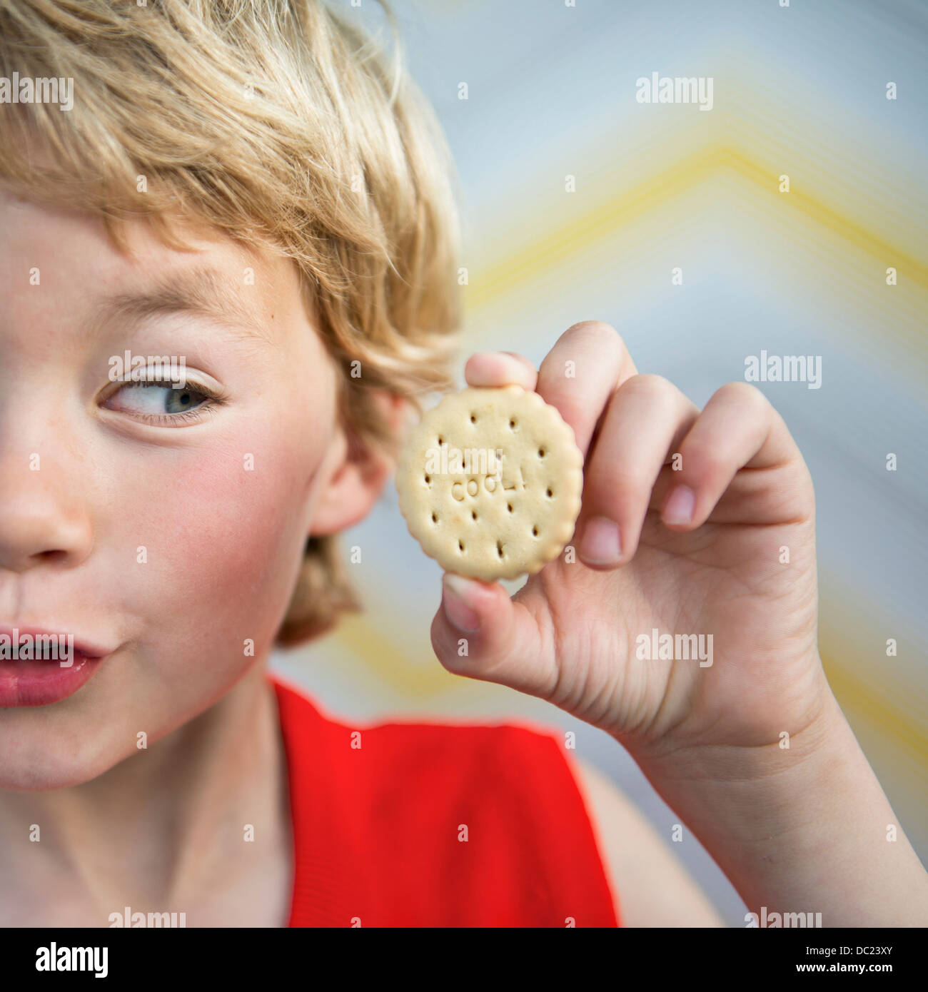Boy holding cool biscuit Stock Photo - Alamy