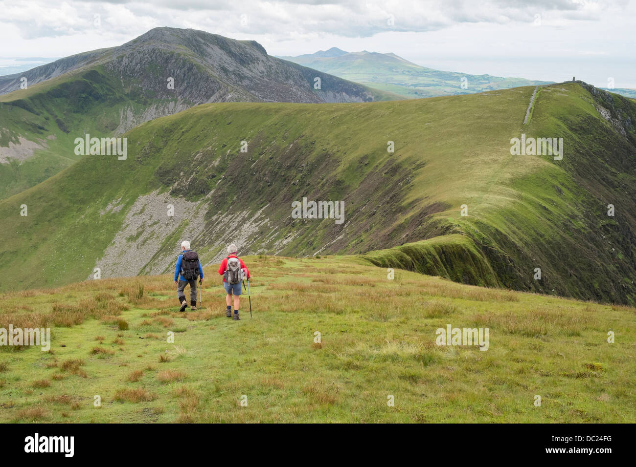 Walkers walking west on path from Trum y Ddysgl to Mynydd Tal-y-mignedd ...