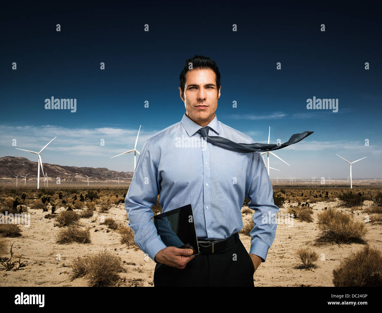 Man standing in front of wind farm Stock Photo - Alamy