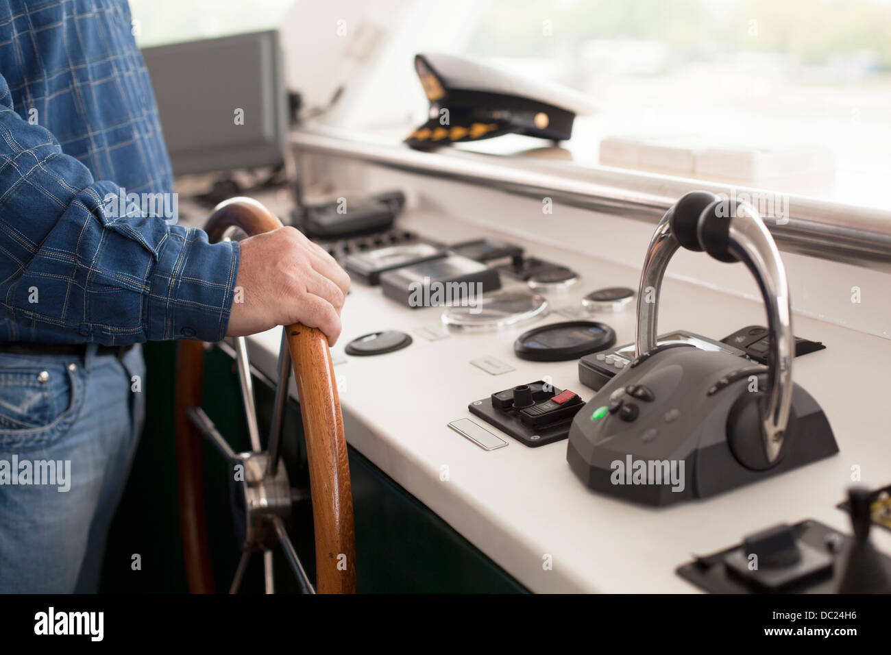 captain driving a boat Stock Photo - Alamy