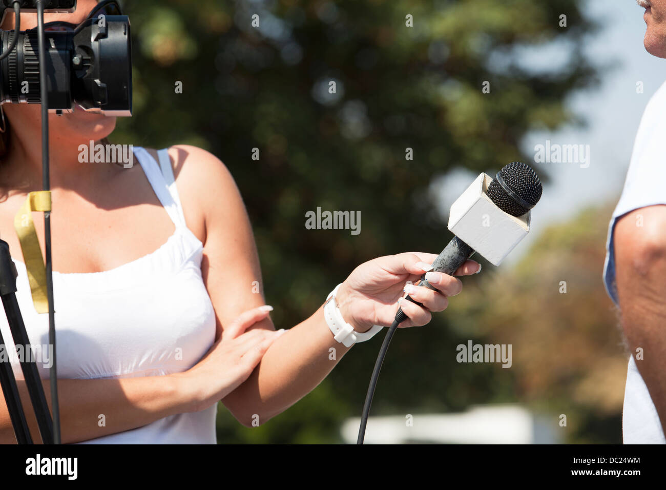 A journalist is making a interview with a microphone Stock Photo - Alamy