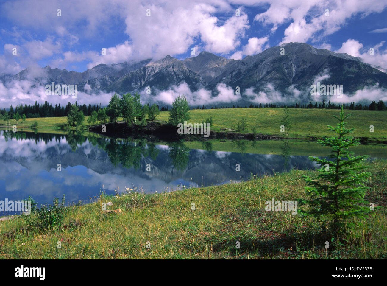 Quarry lake in Canmore as clouds clear from Mount Lady MacDonald Stock ...