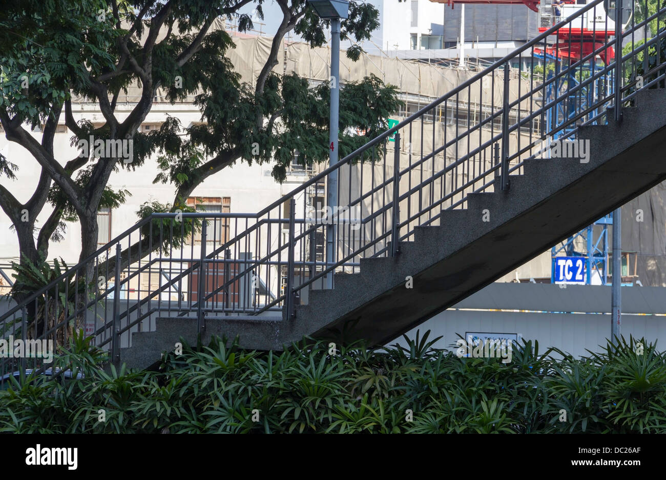 Staircase on a road in Singapore leading to a foot overbridge. The road ...