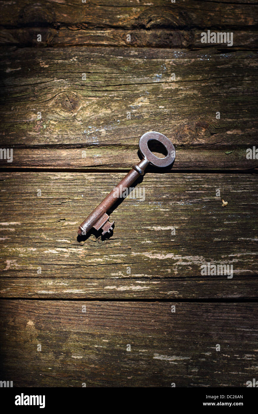 Big key on old wooden boards in sunlight Stock Photo - Alamy