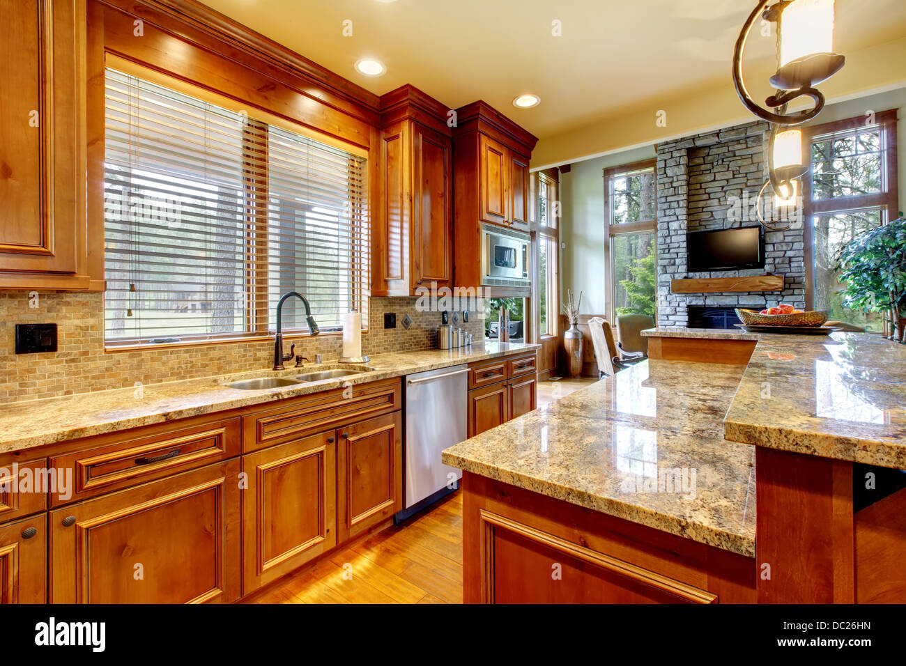Luxury wood kitchen with granite countertop Stock Photo - Alamy
