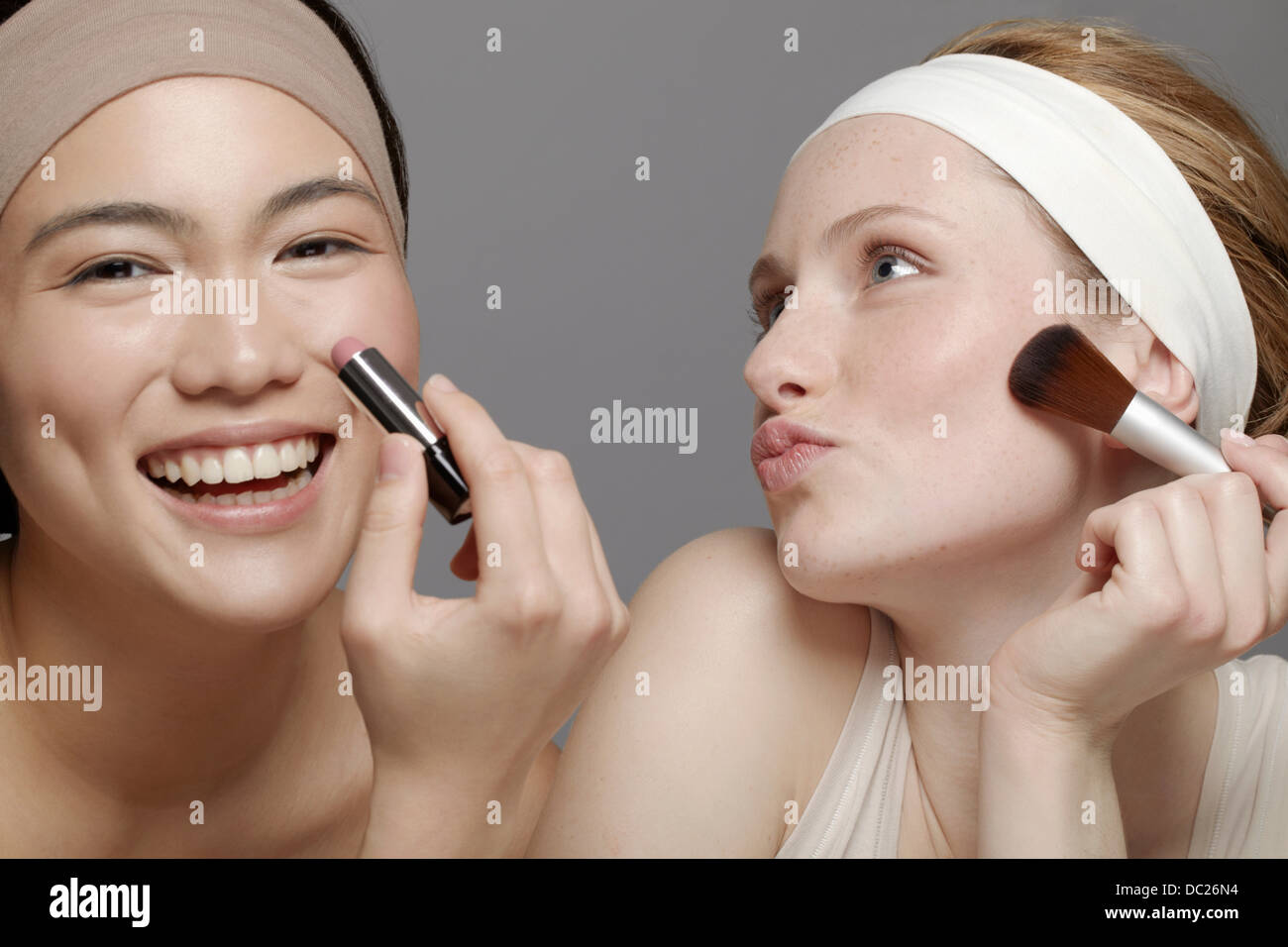 Young women putting on make up Stock Photo - Alamy