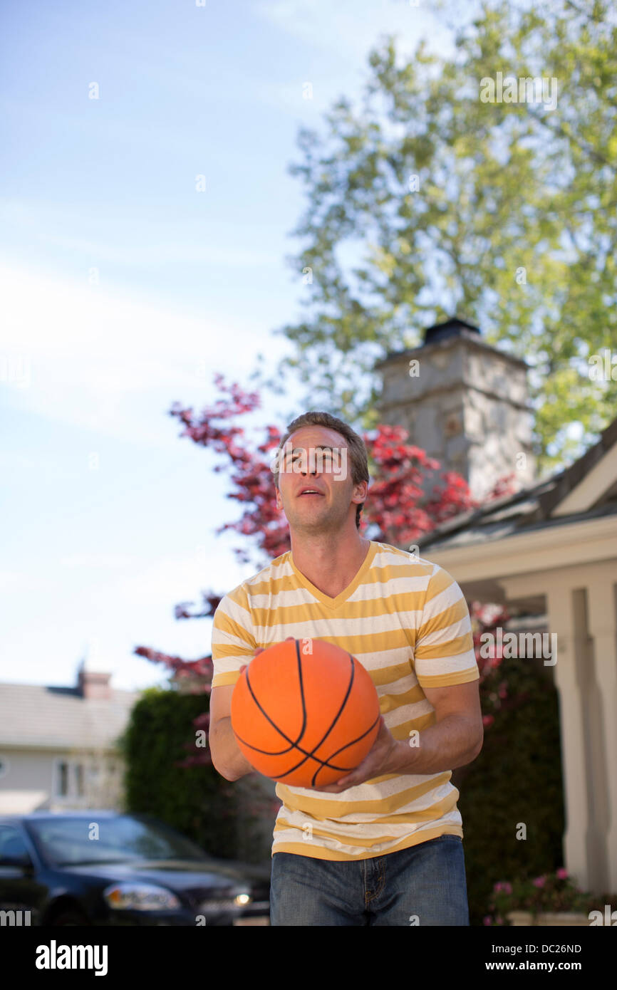 Young man holding basketball Stock Photo - Alamy Young man holding basketball Stock Photo - Alamy