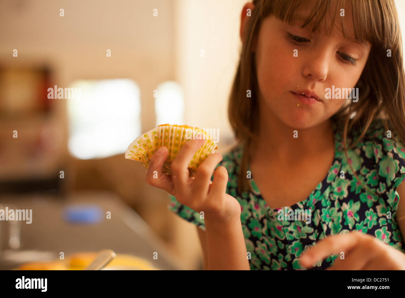 Sad girl holding cupcake Stock Photo - Alamy