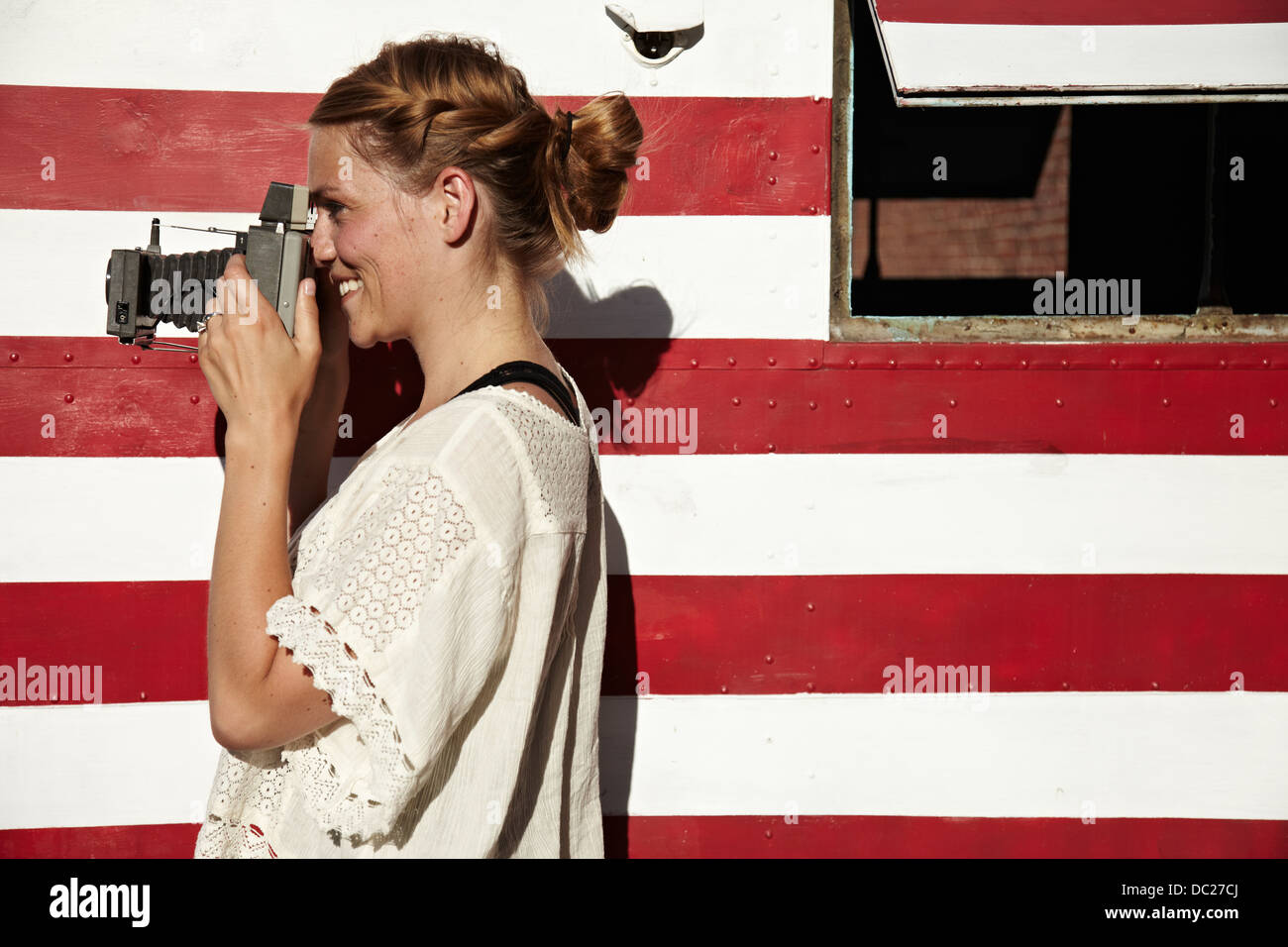 Woman taking photograph using vintage camera Stock Photo - Alamy