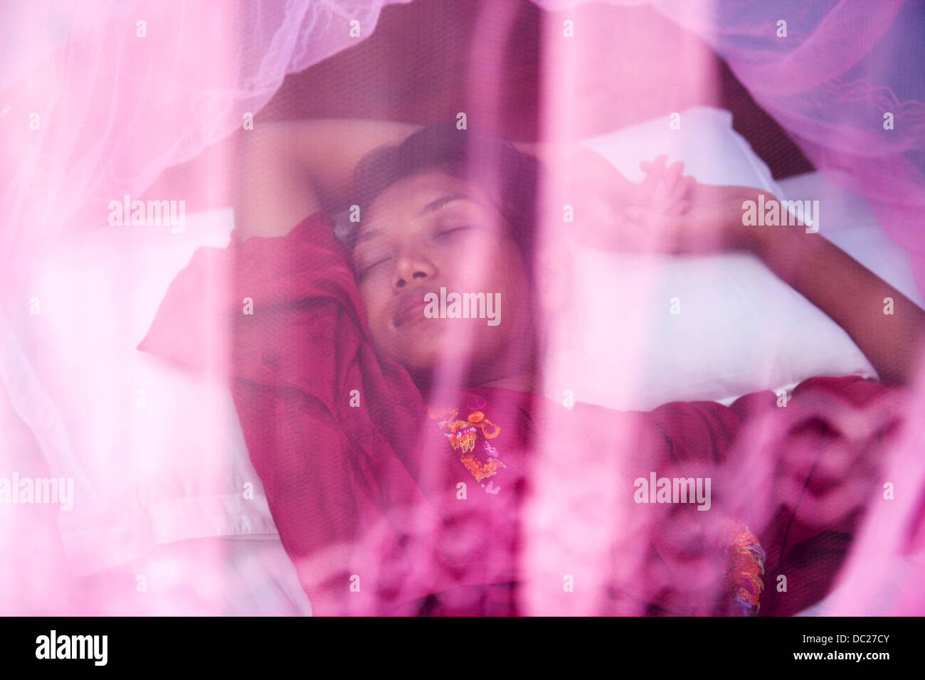 woman sleeping under a mosquito net Stock Photo - Alamy