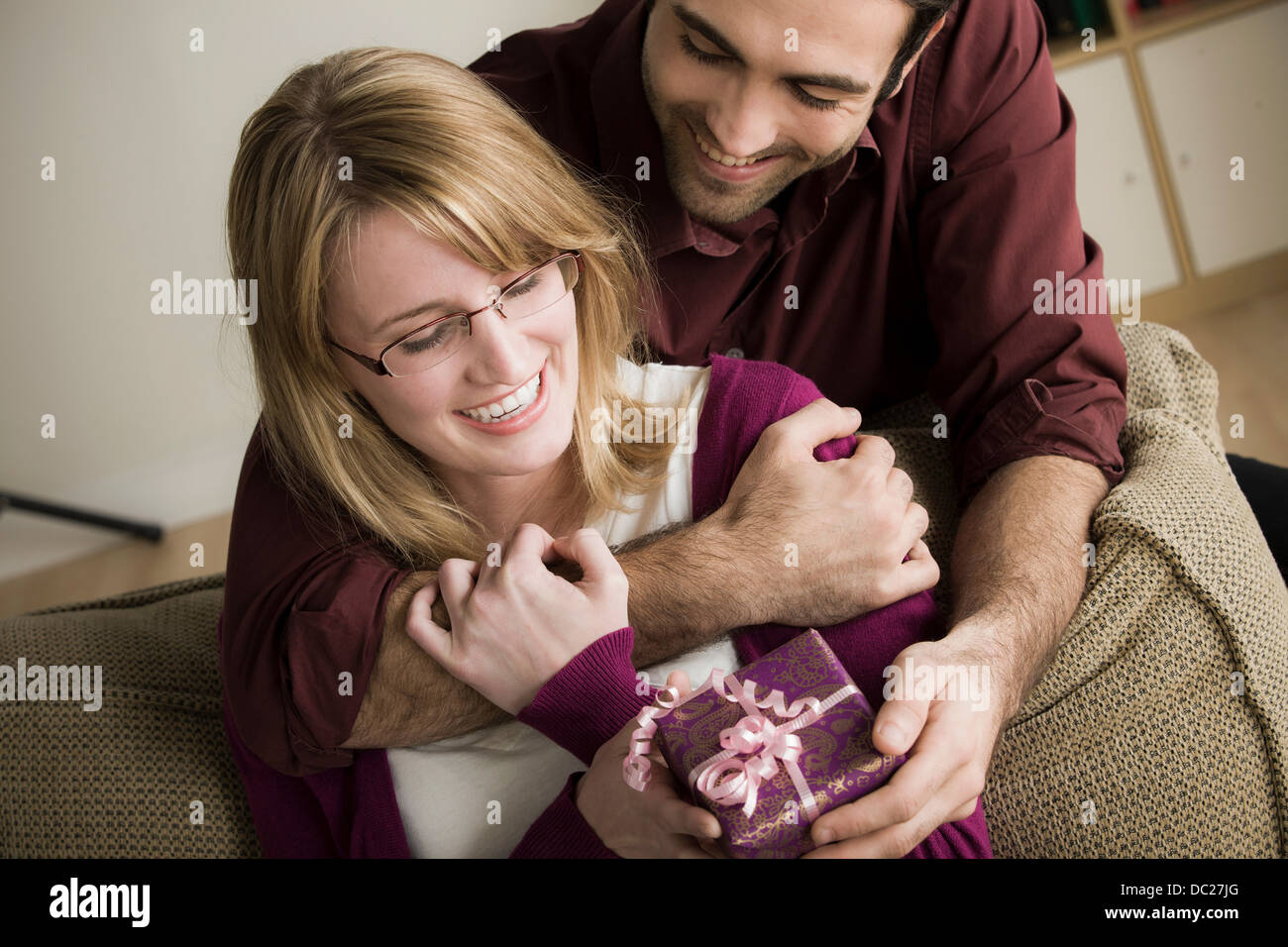 Young man giving woman gift Stock Photo - Alamy
