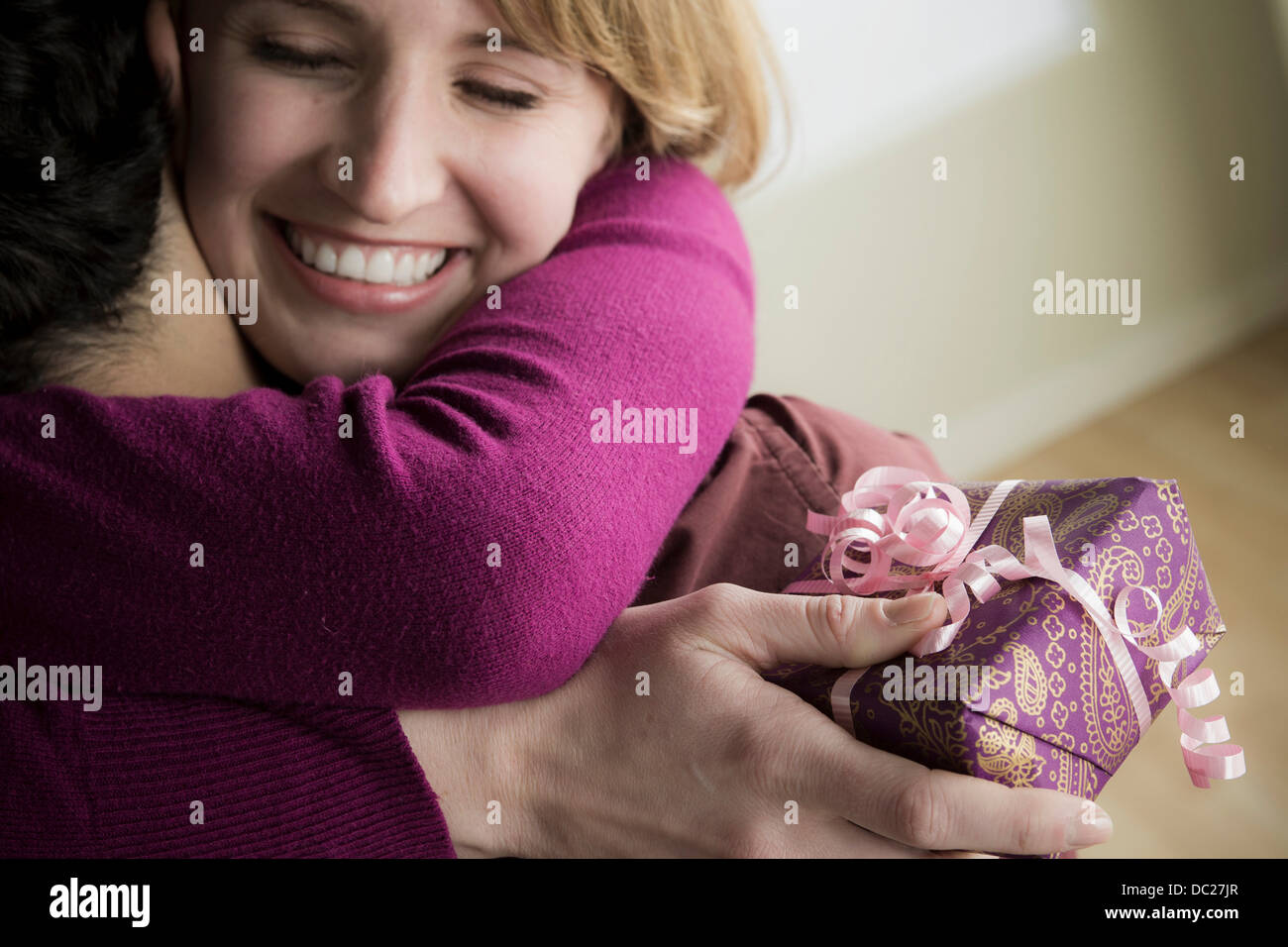 Young woman hugging gift box hi-res stock photography and images - Alamy