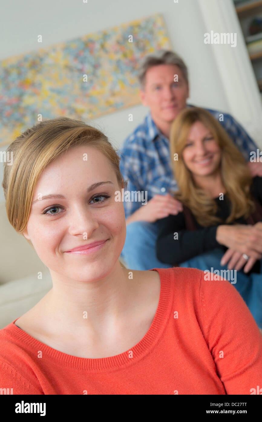 Portrait of teenage girl with parents in background Stock Photo - Alamy