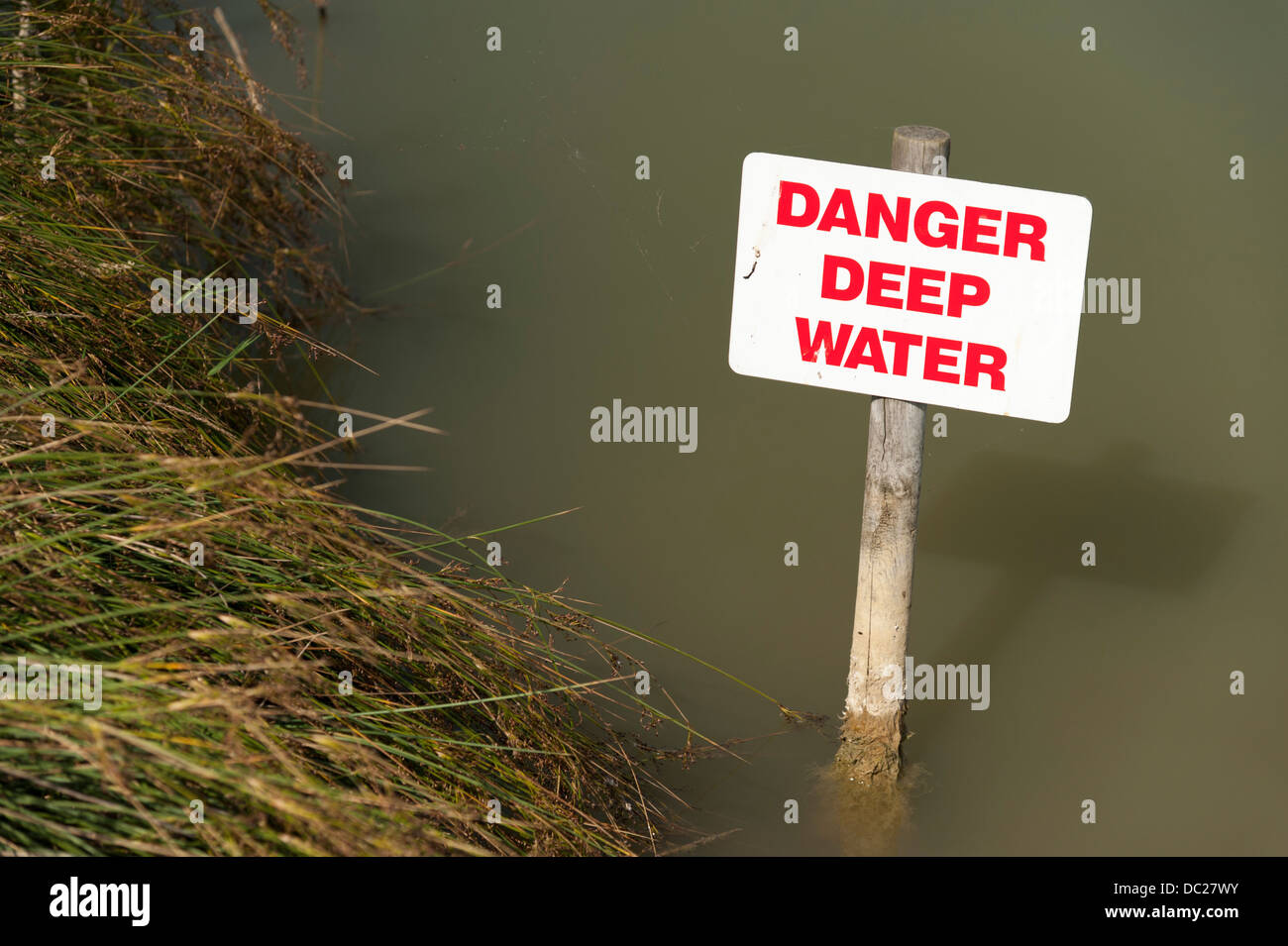 Danger deep water sign in a a lake UK Stock Photo - Alamy