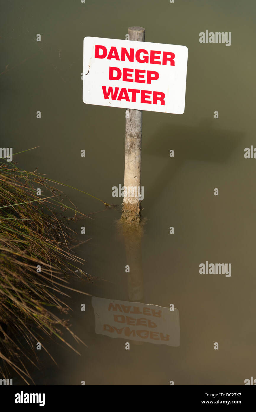 Danger deep water sign in a a lake UK Stock Photo - Alamy