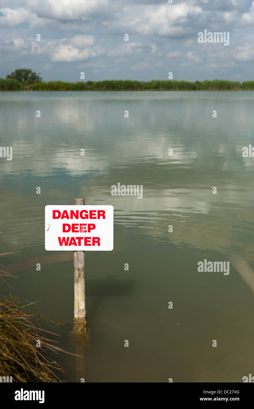 Danger deep water sign in a a lake UK Stock Photo - Alamy