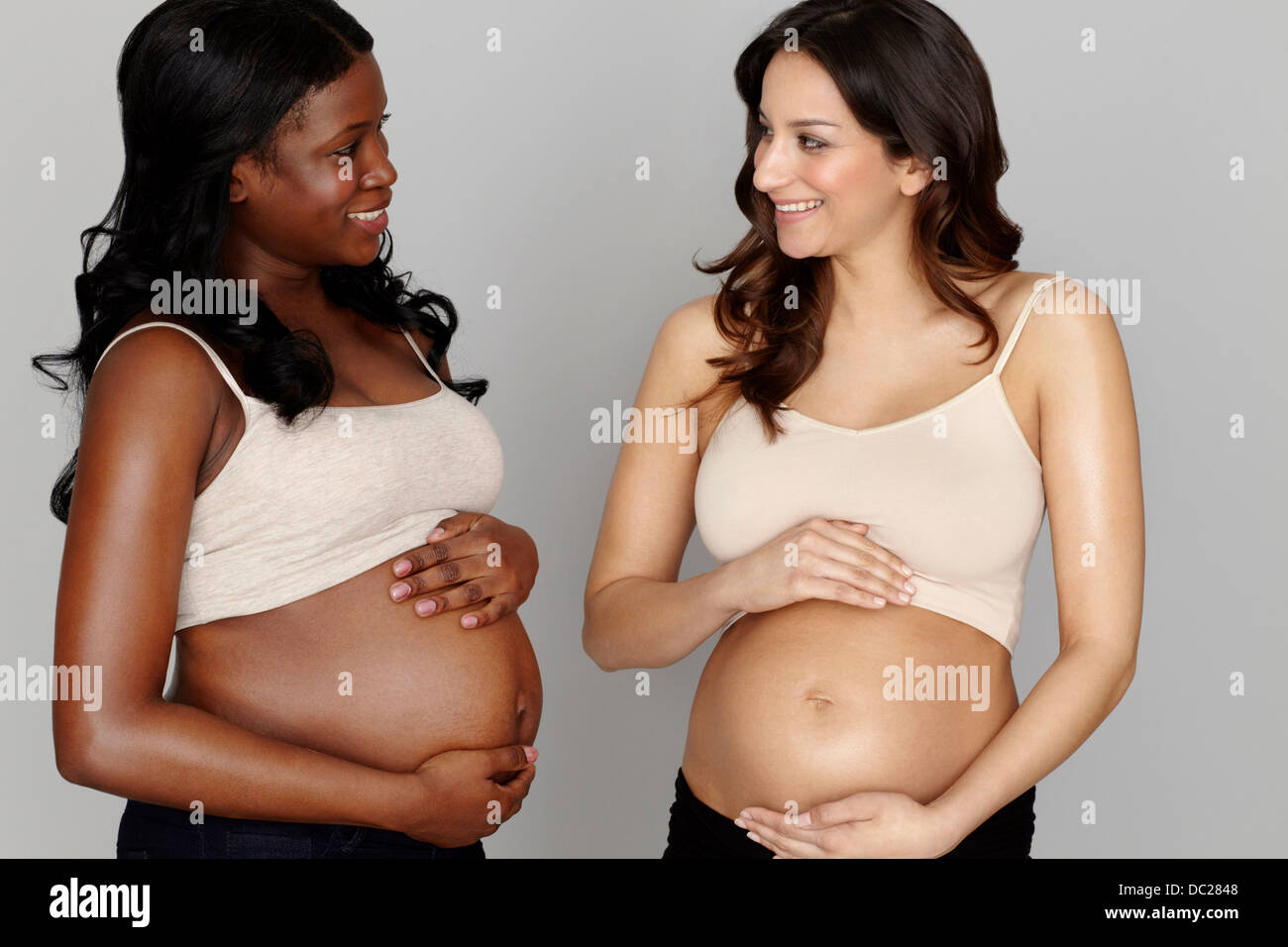 Two pregnant women touching stomachs Stock Photo - Alamy