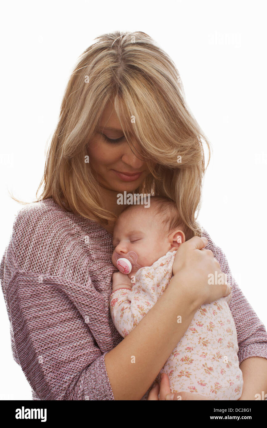 Mother holding newborn baby daughter Stock Photo - Alamy