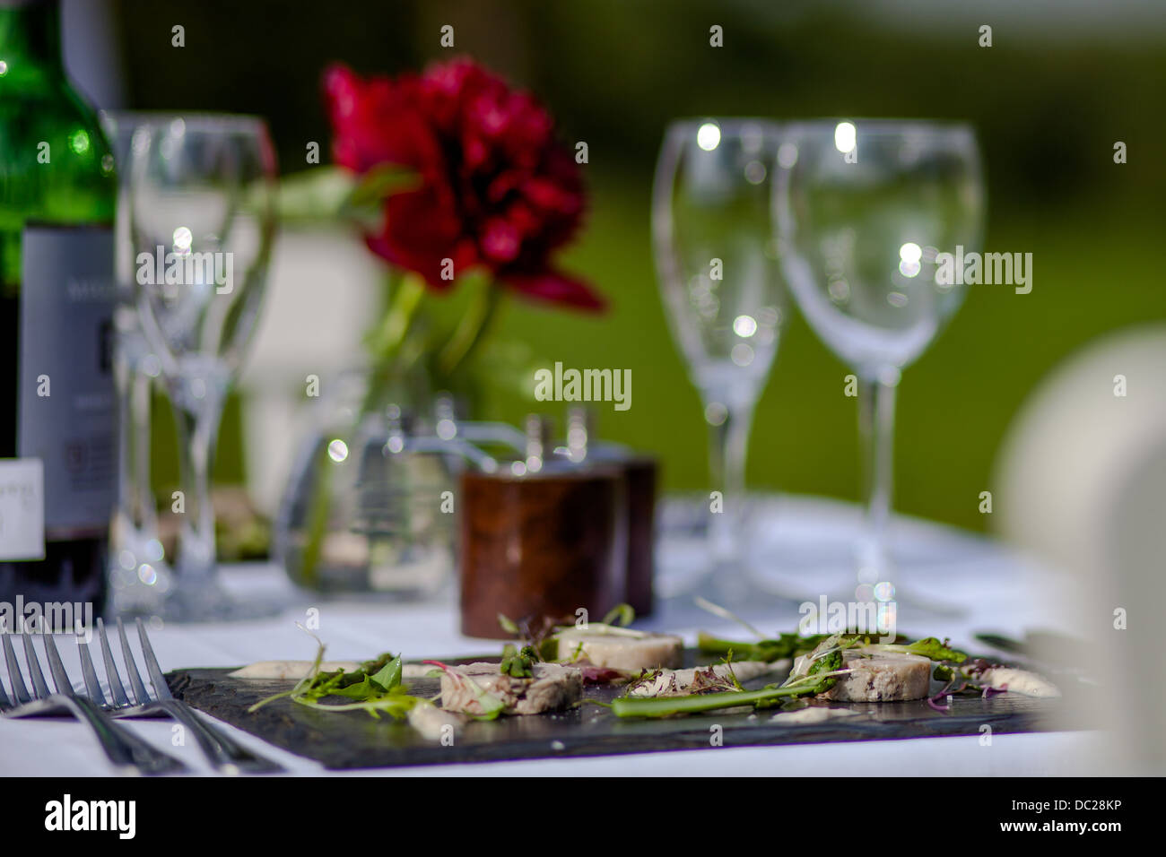 Outdoor dining with starter served on black slate Stock Photo - Alamy