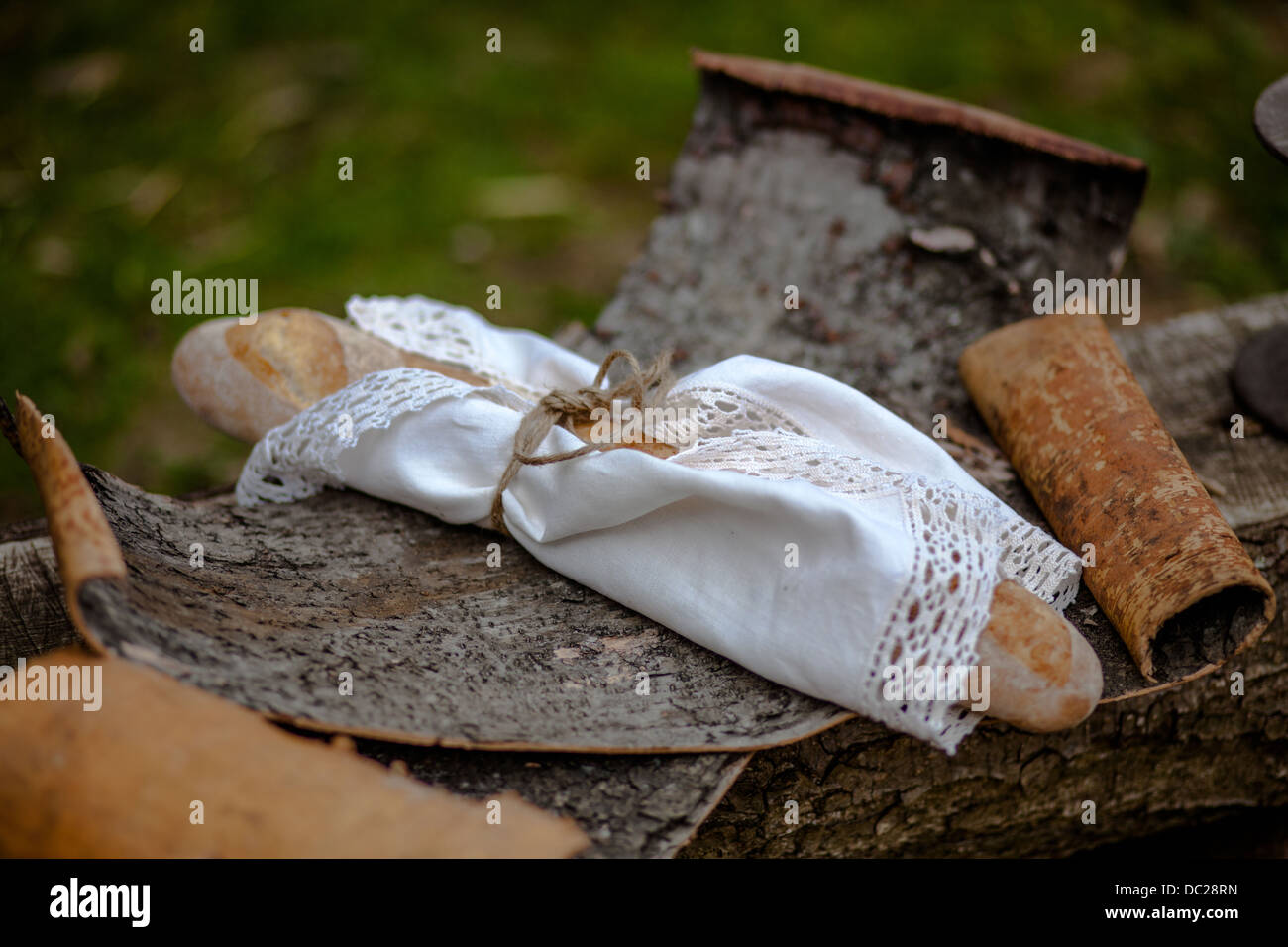 Bread wrapped in linen and tied with string on bark Stock Photo - Alamy
