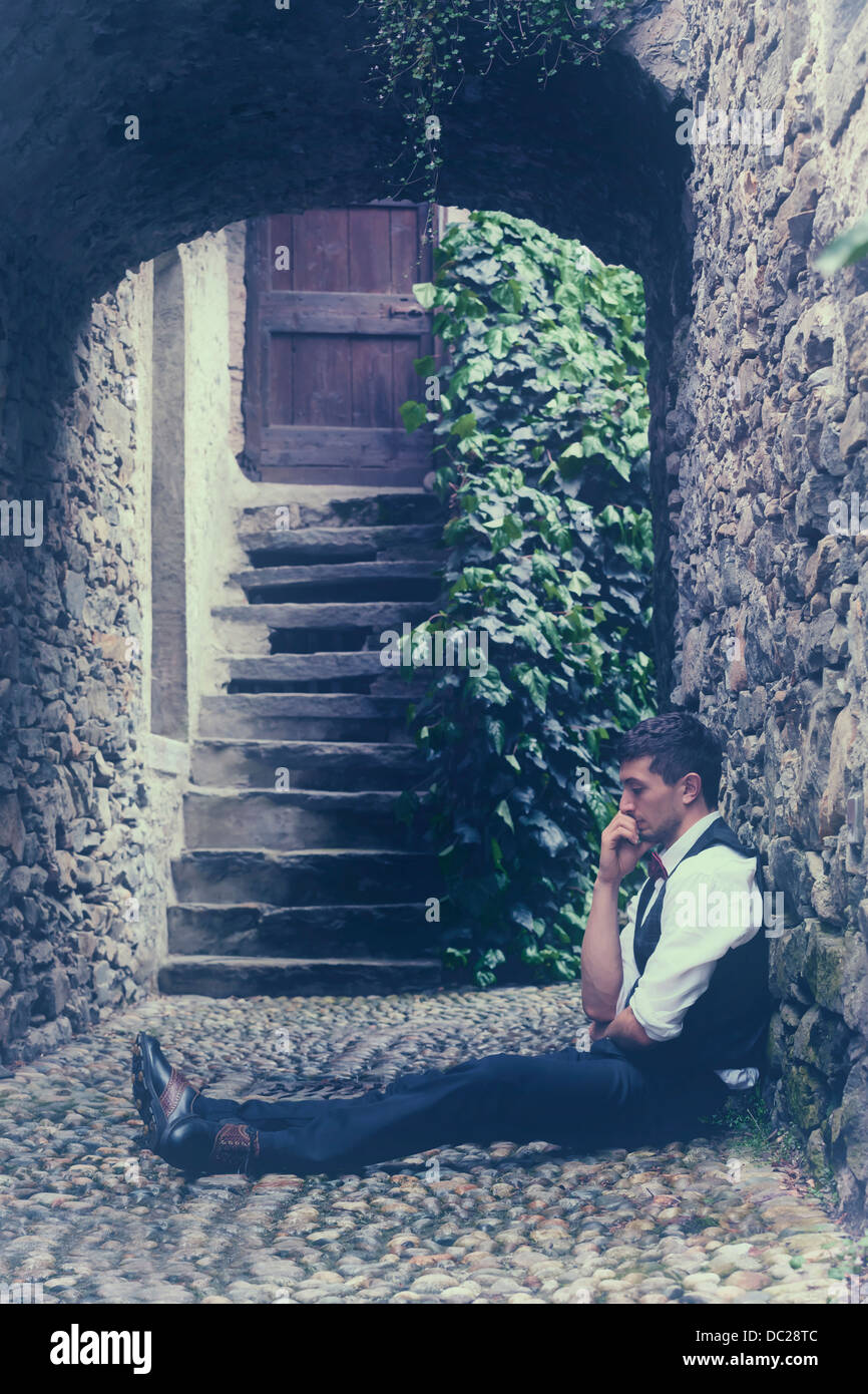 Sad man sitting in dark hi-res stock photography and images - Alamy