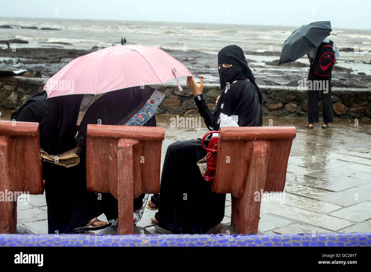Muslim girl with umbrella in monsoon rain Stock Photo - Alamy